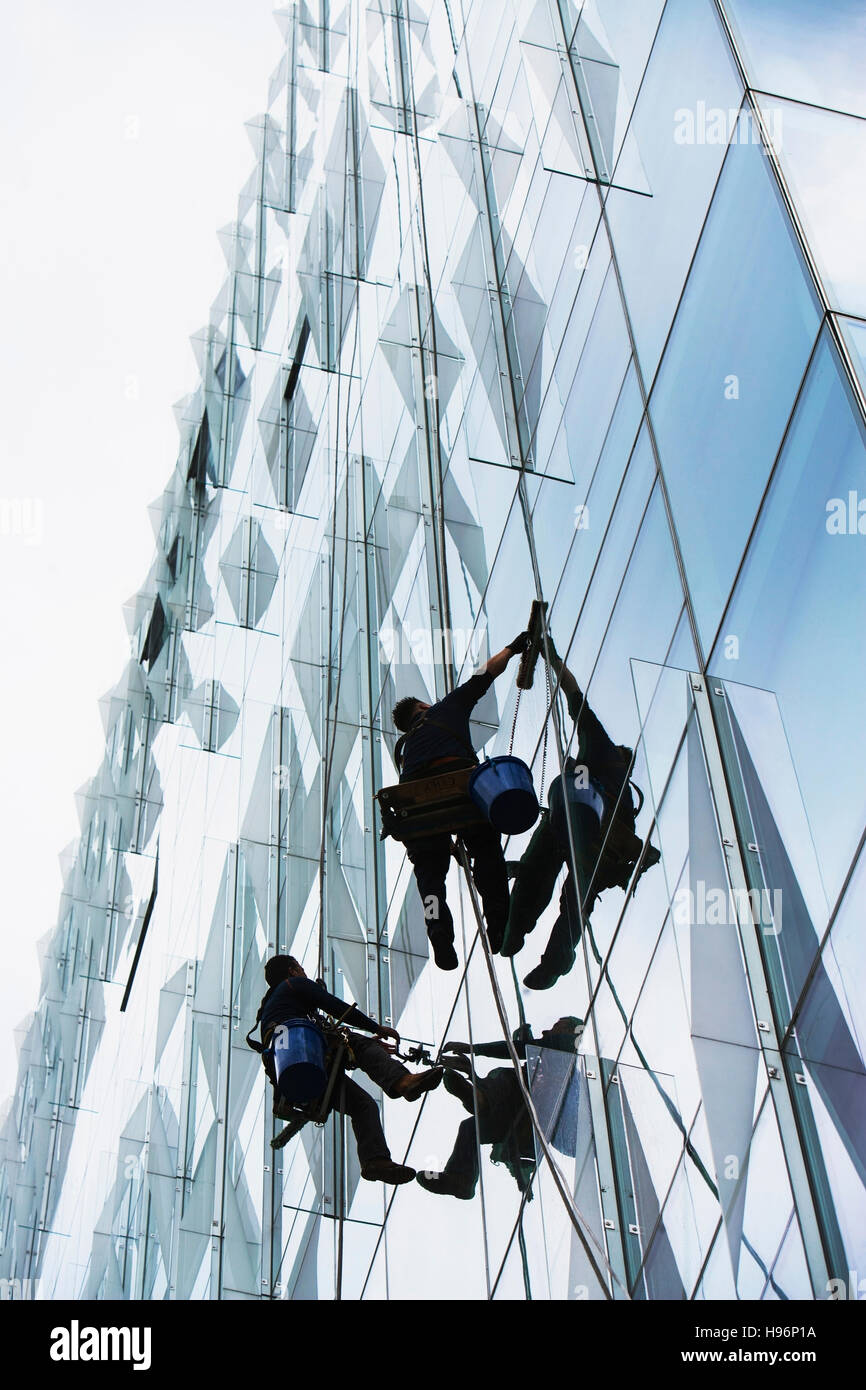 USA, New York, New York City, Windows washers cleaning glass facade of ...