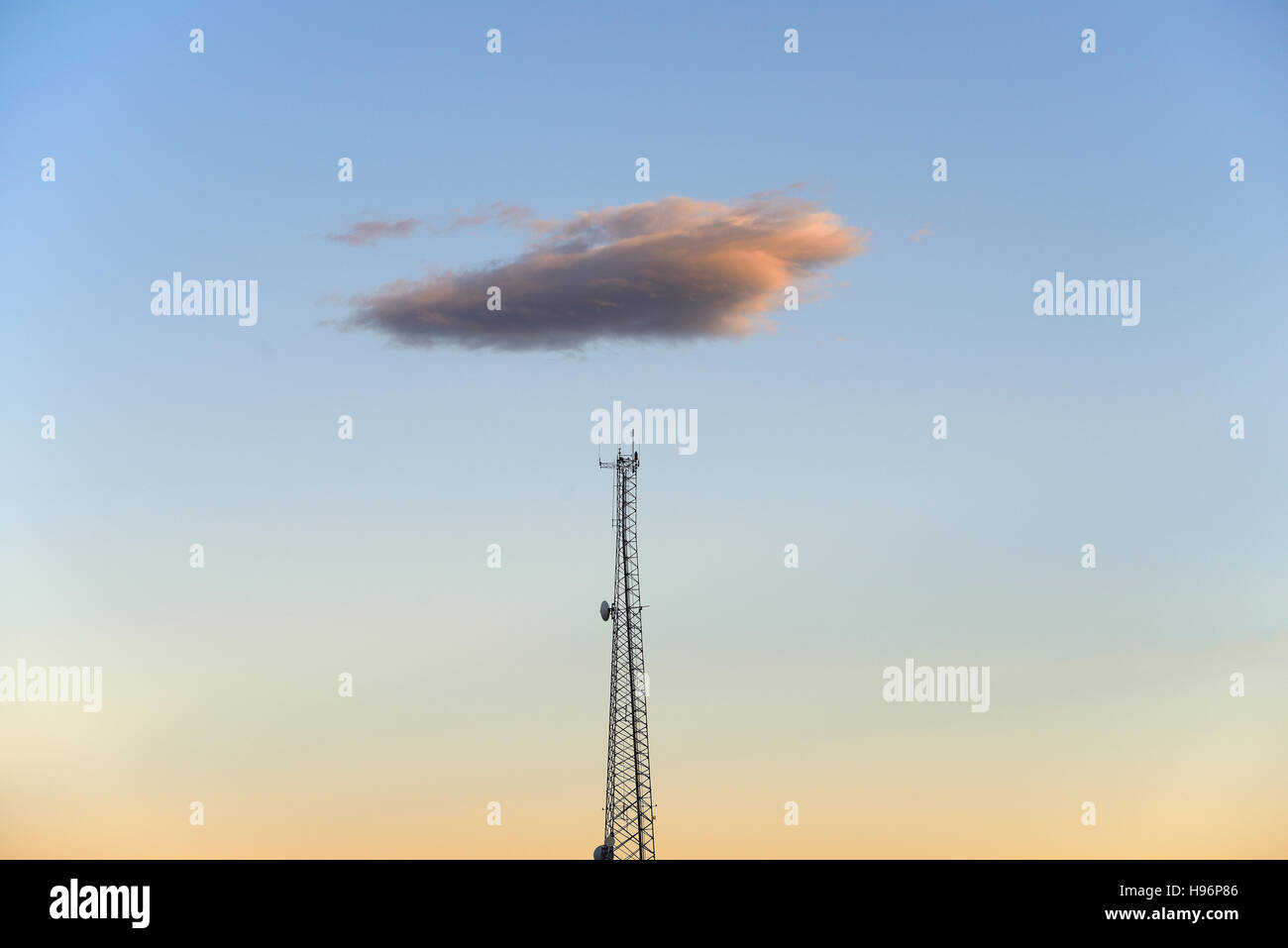 Cloud over communication tower at dusk Stock Photo - Alamy