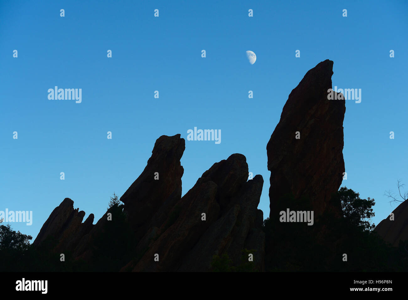 USA, Colorado, Moon over silhouette of rocks in Roxborough State Park ...
