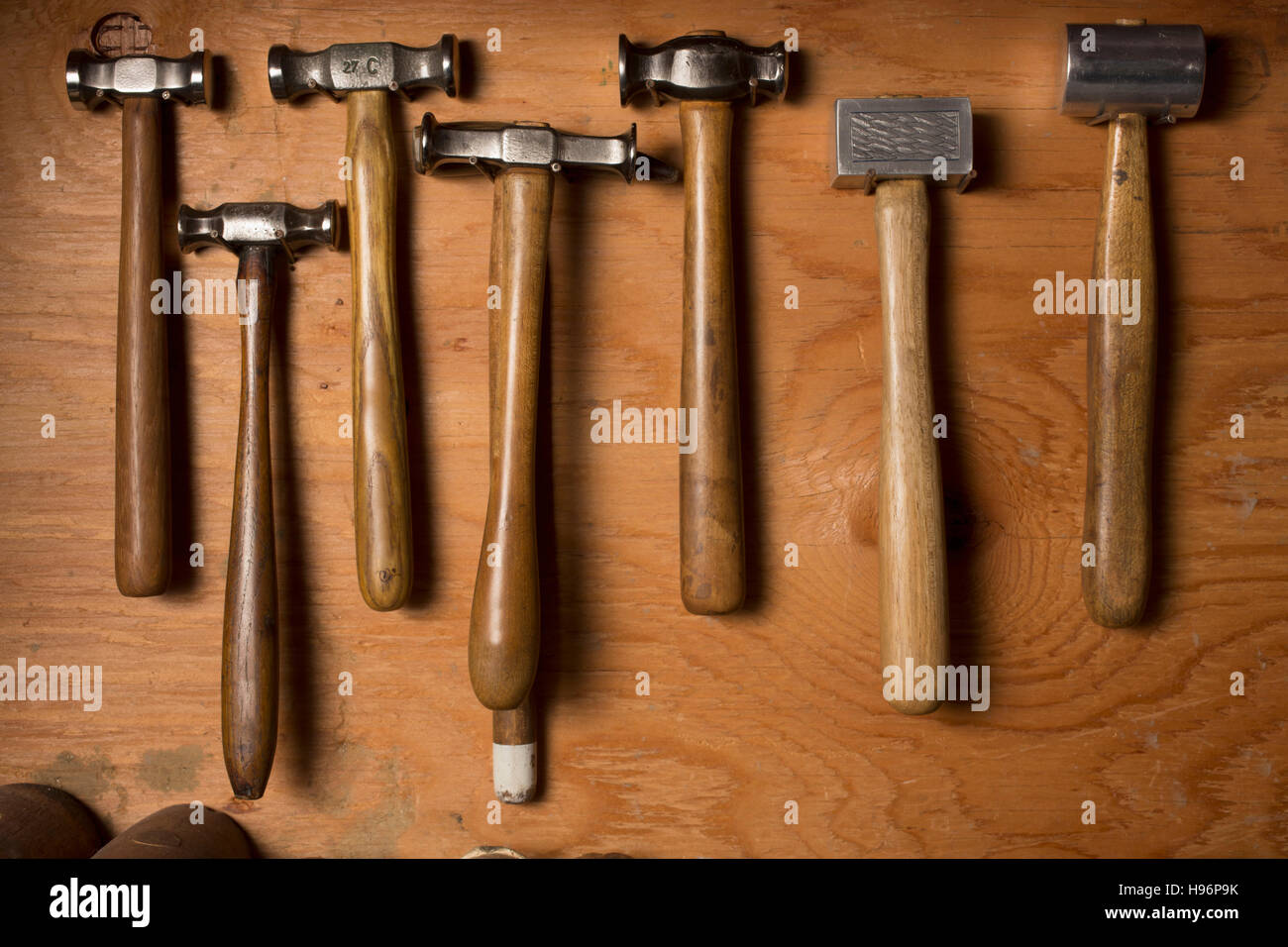 Collection of hammers lying on wood Stock Photo - Alamy
