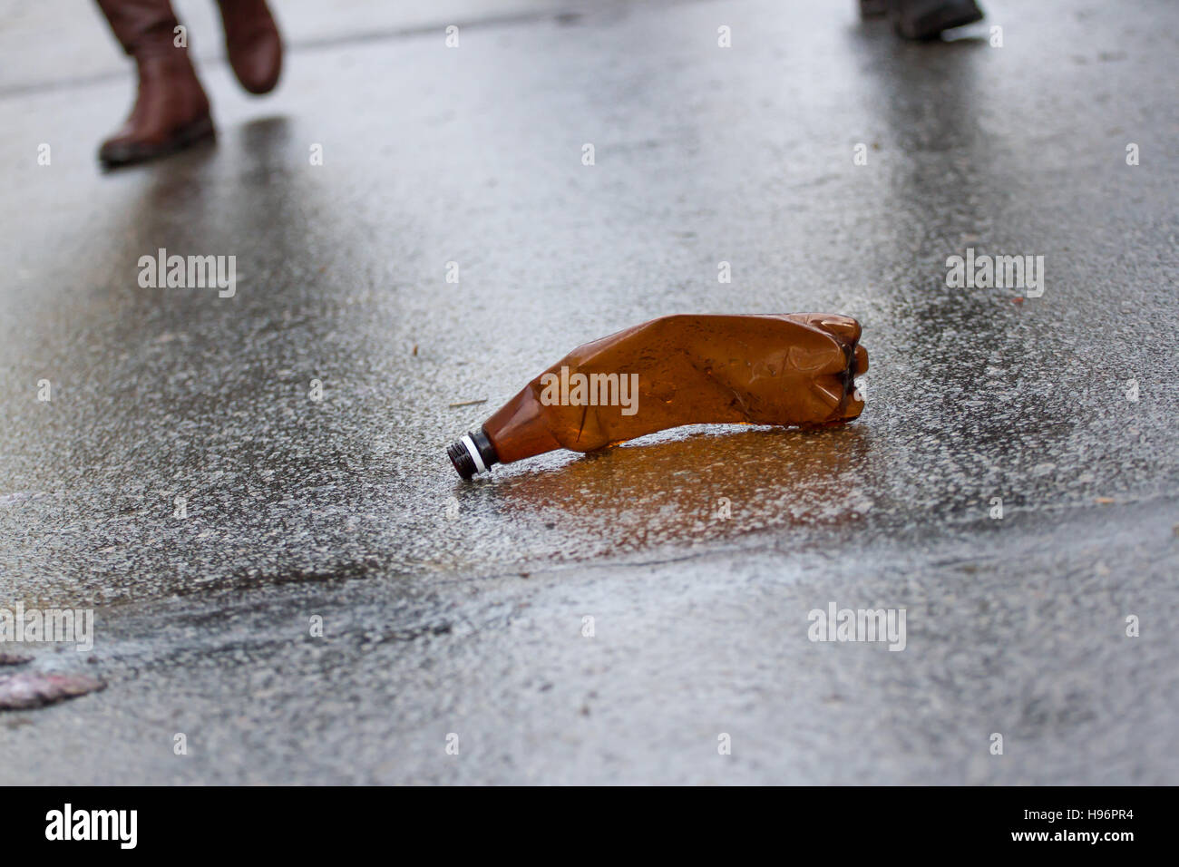One compressed plastic bottle isolated. Waste in cityscape Stock Photo ...