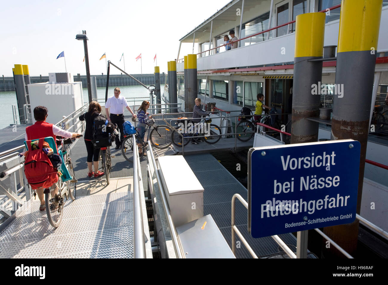 Cyclists at the shipping pier, ship, harbour, Lake Constance ...