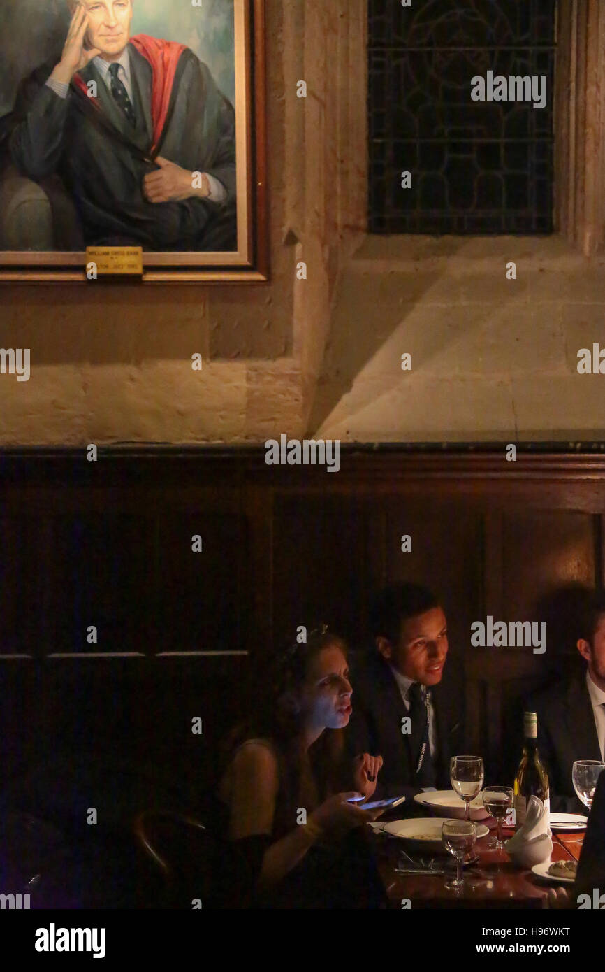 Students having dinner in the dining hall of Exeter College in Oxford ...