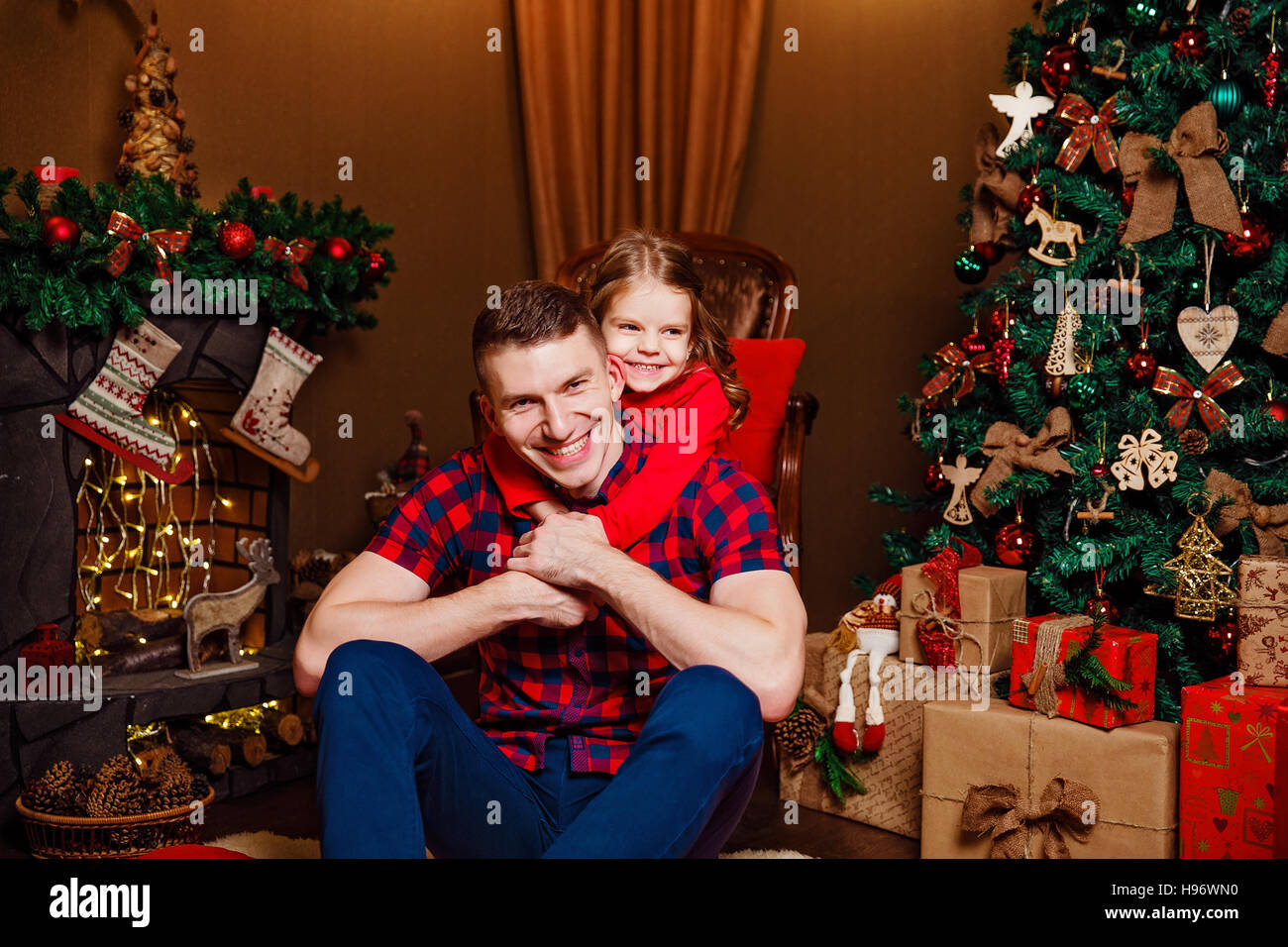 Child with dad near Christmas tree Stock Photo - Alamy