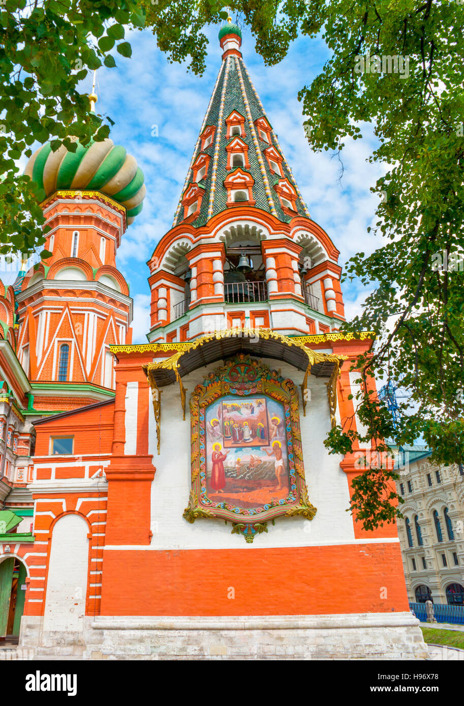 The bell tower with an icon on the wall and many small windows on the ...