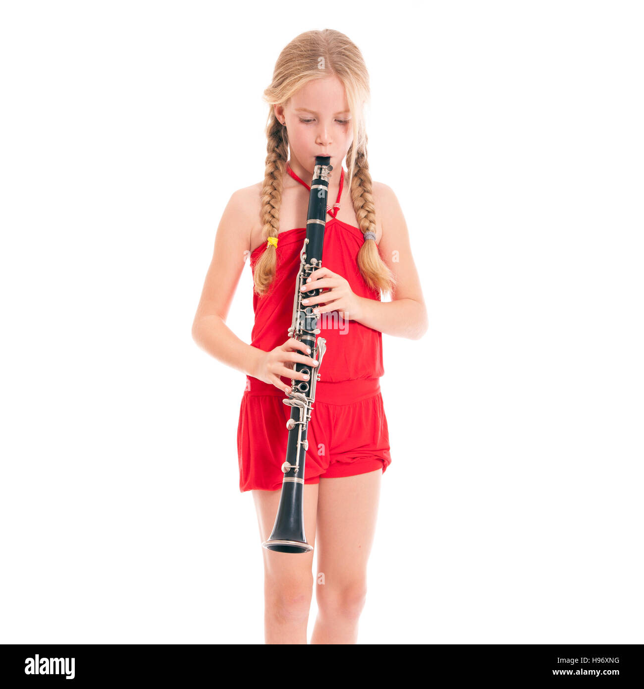 square picture of young girl in red playing the clarinet against white ...