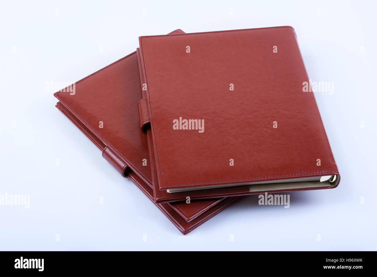 Red leather luxury diaries on white background Stock Photo - Alamy