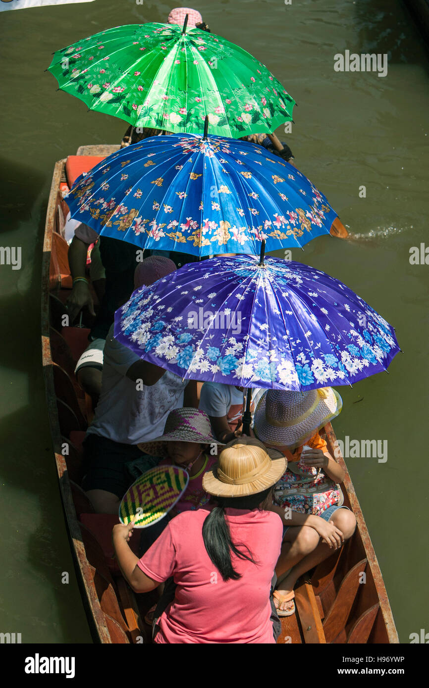 Tourists with coloured parasols floating market Damnoen Saduak outside ...