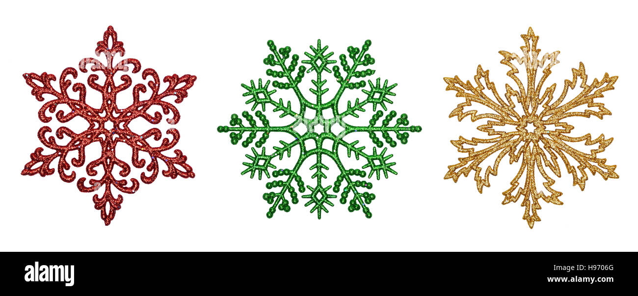 Three decorative snowflakes: golden, red and green isolated on white ...