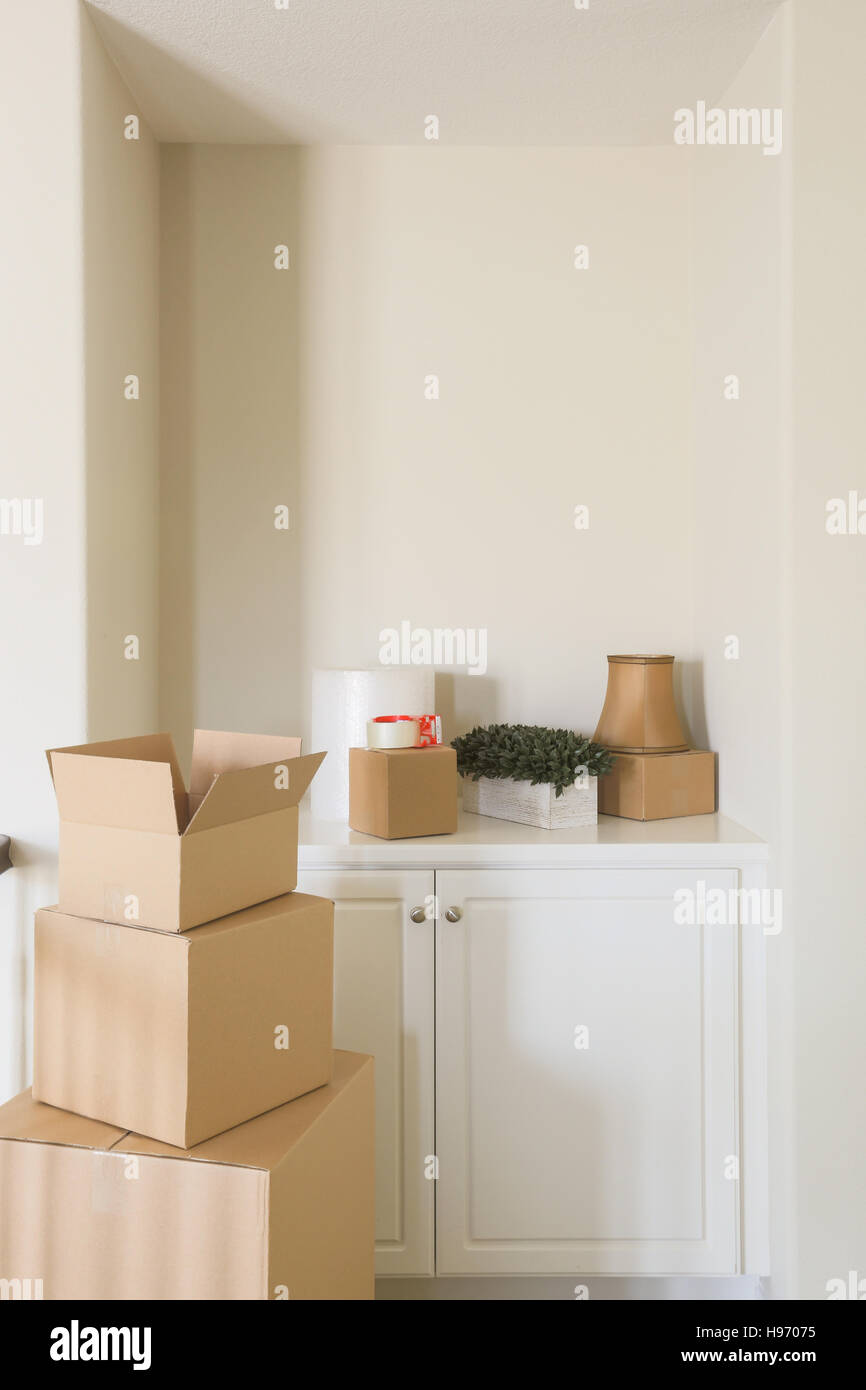 Variety of Packed Moving Boxes and Materials In Empty Room Stock Photo ...