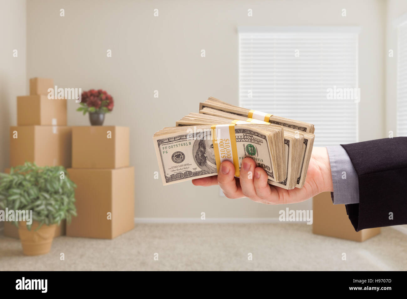 Man Handing Over Cash In Room with Packed Moving Boxes Stock Photo - Alamy
