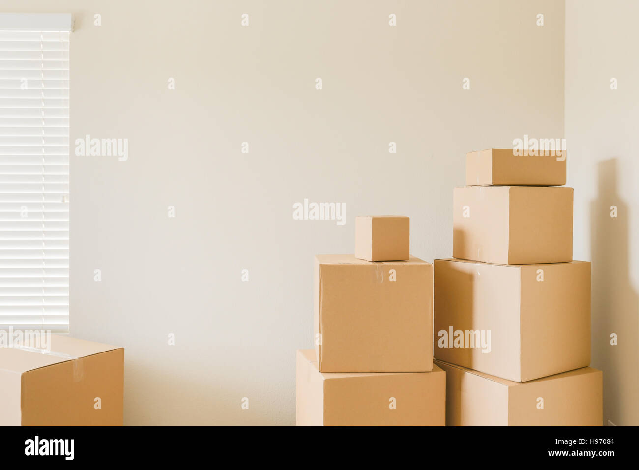 Variety of Packed Moving Boxes In Empty Room with Room For Text Stock ...