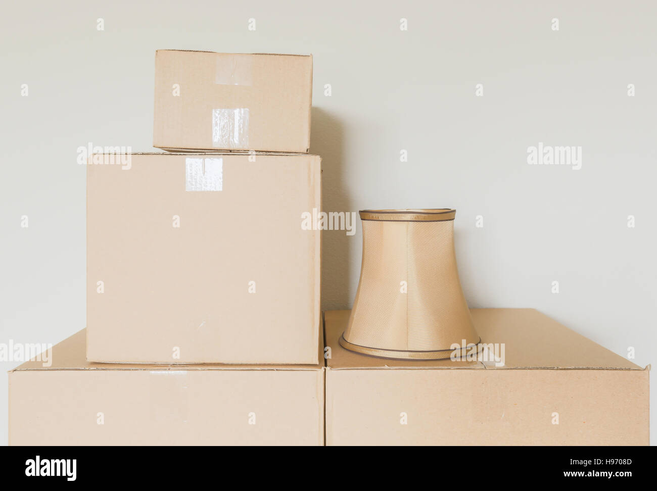 Variety of Packed Moving Boxes and Lamp Shade In Empty Room Against ...