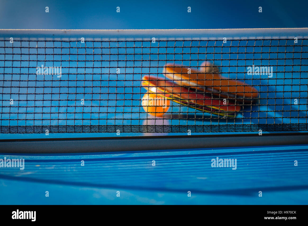 Two table tennis racket with a ball on the table behind the net Stock ...
