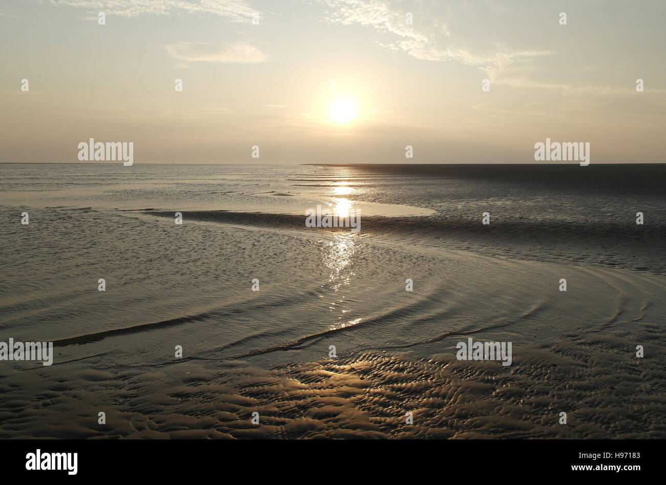 Tide rising from River Ribble onto sand beach with small wave ...
