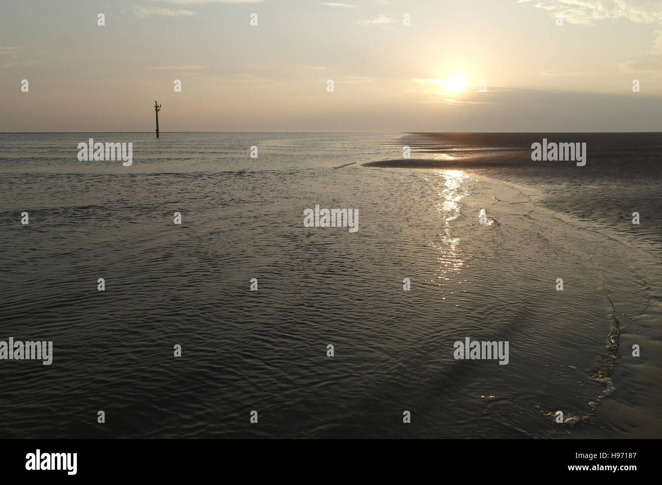Rising tide, from the channel of the River Ribble, flooding sand beach ...