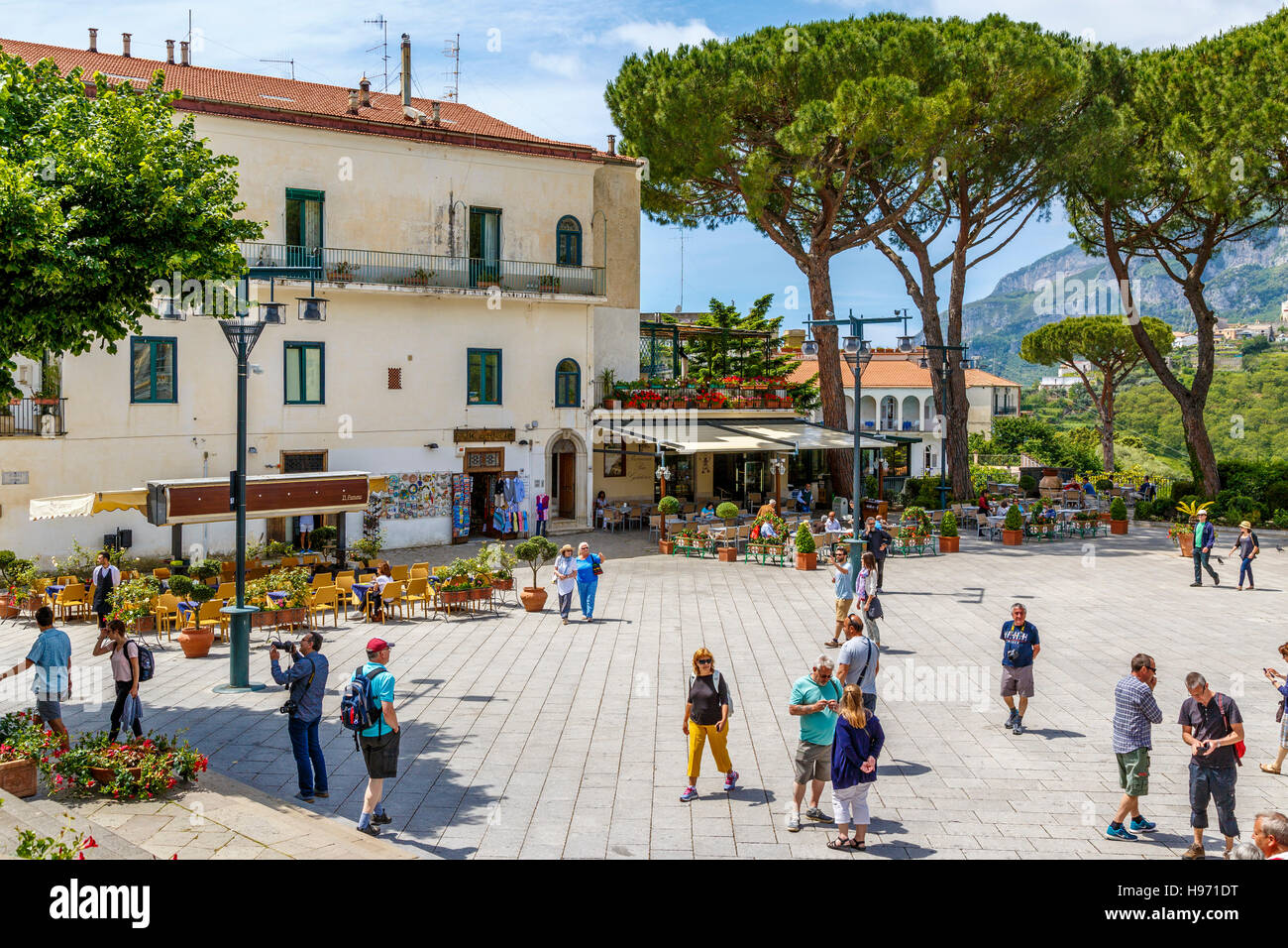 Visitors and tourists enjoying the cafés and quiet of the Piazza ...