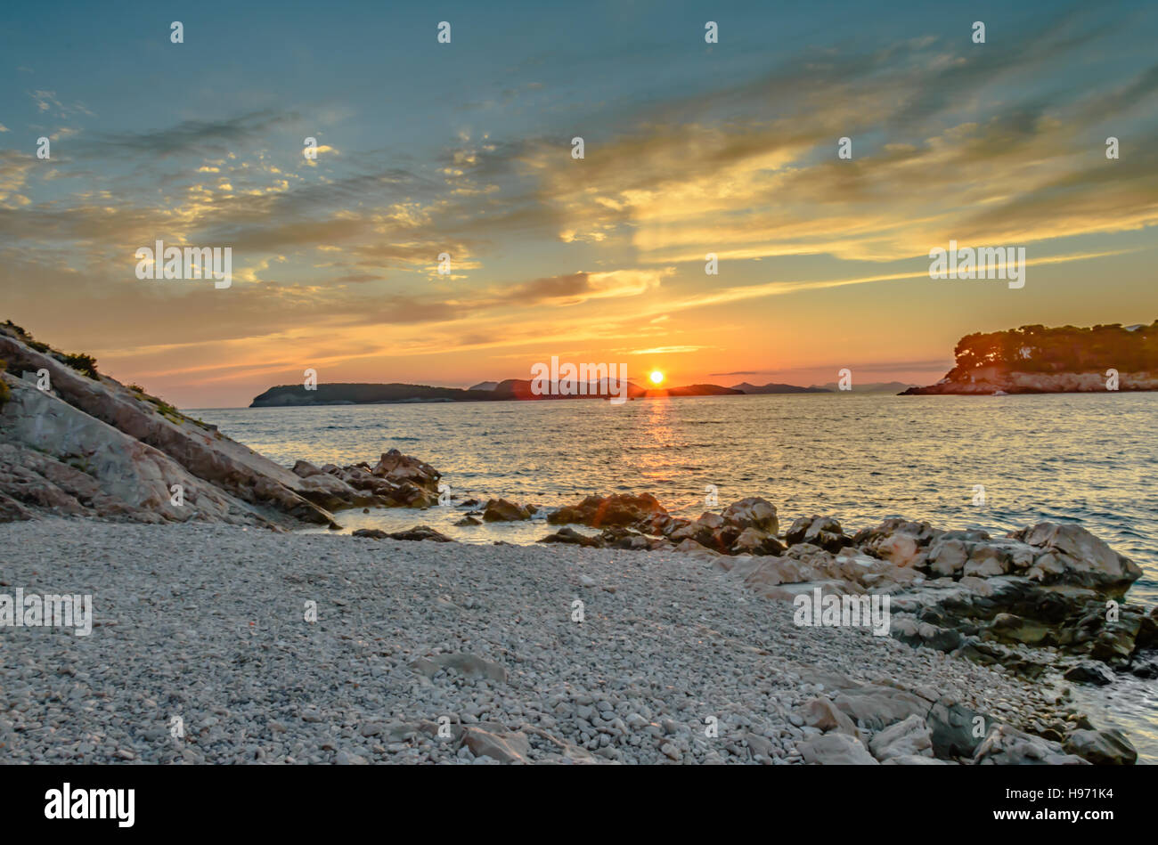 Sunset over beach Stock Photo - Alamy