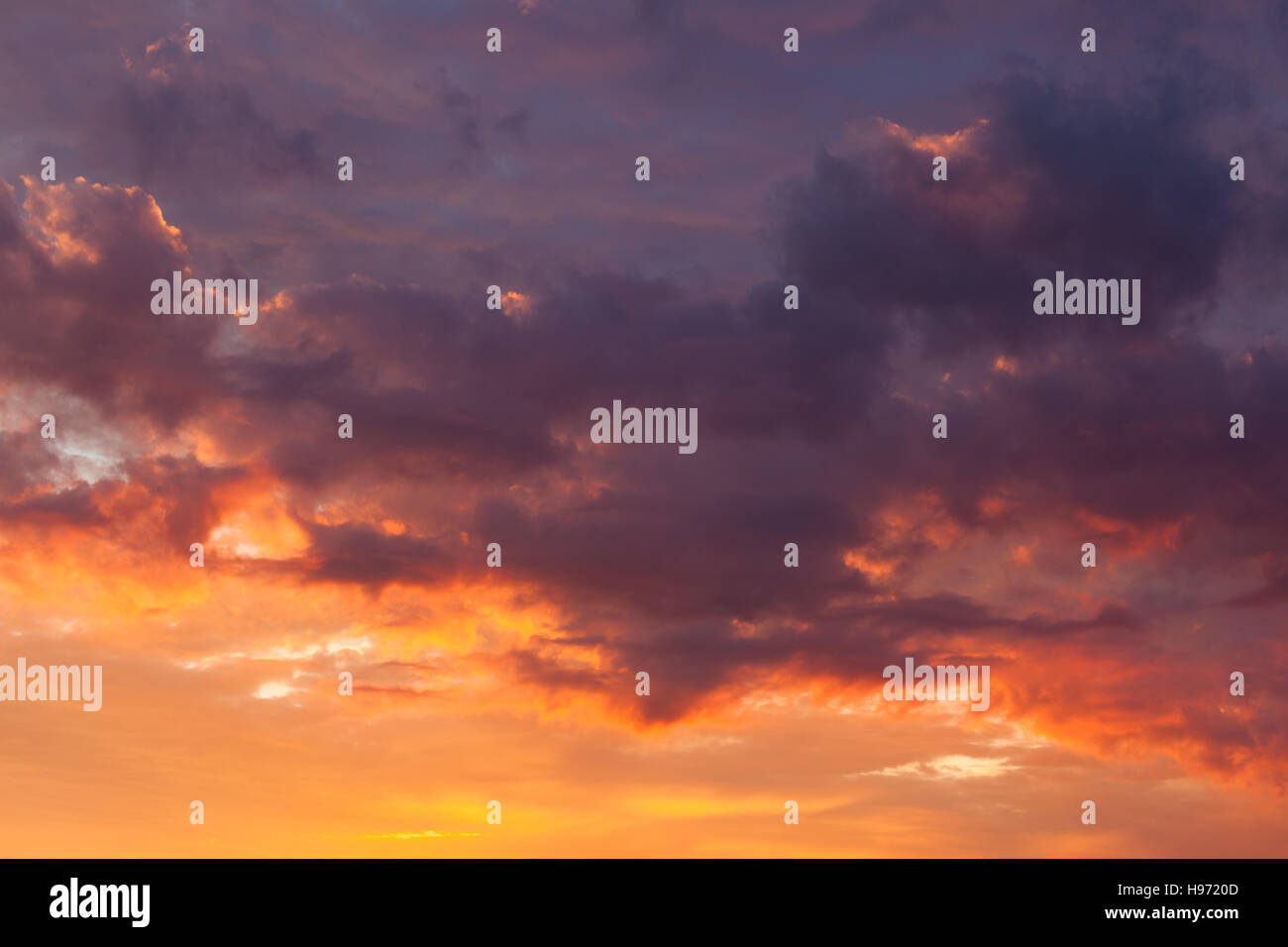 Fiery vivid sunset sky clouds Stock Photo - Alamy
