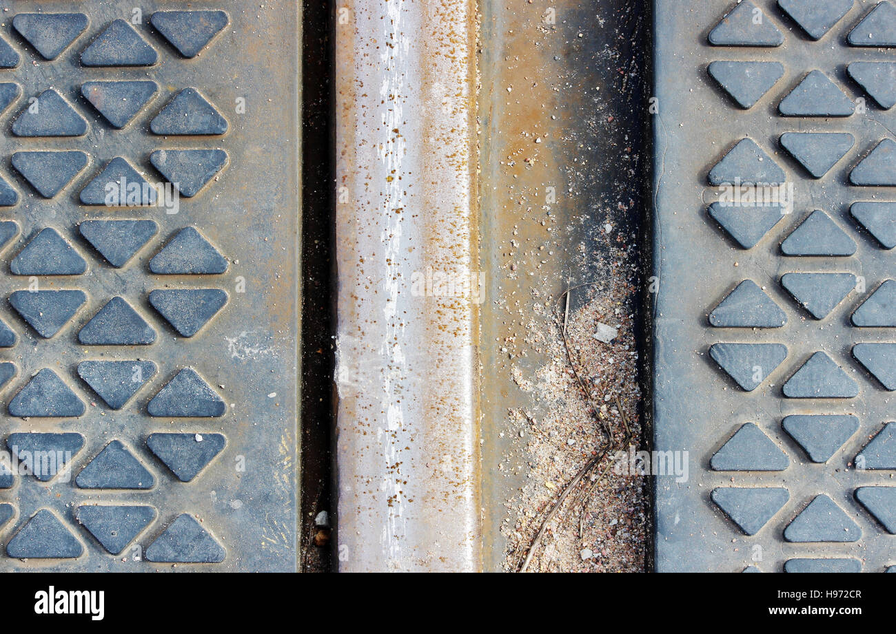 the texture of the metal rails and the rubber coating on the railway ...