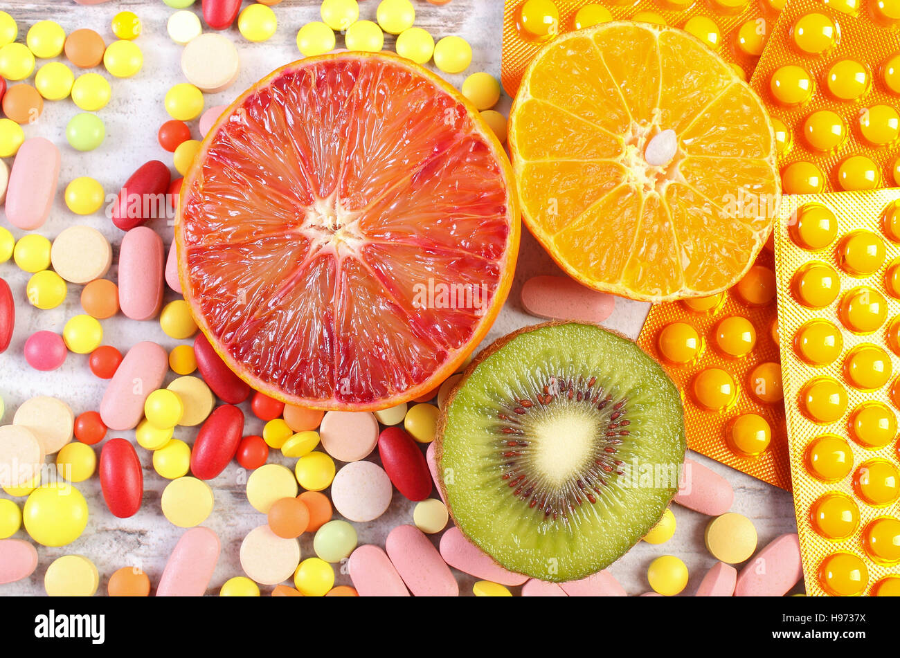 Fresh natural fruits and pills, tablets or capsules, choice between ...