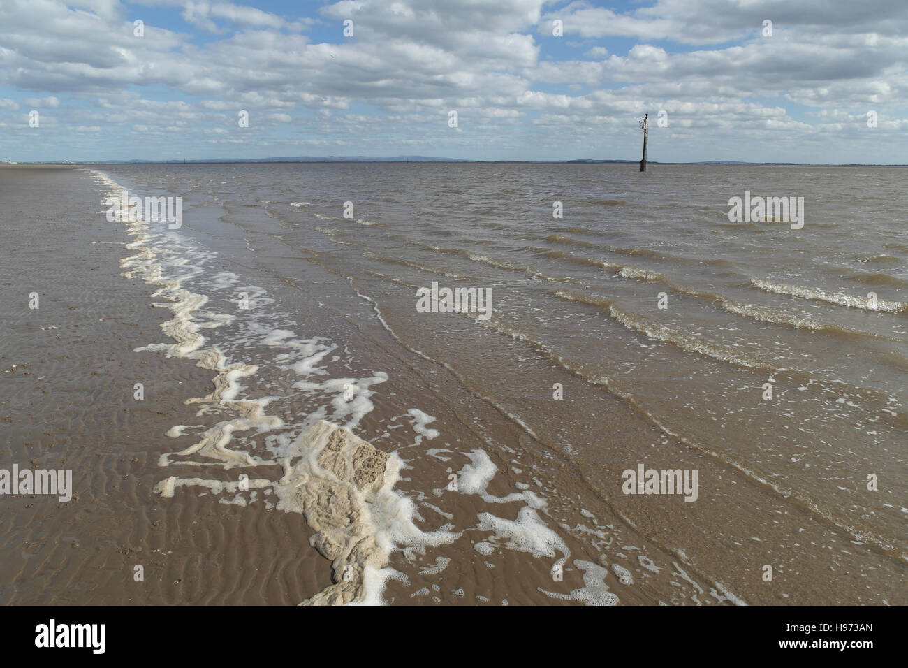 Expanse sand mid distance extending low tide calm seawater background ...