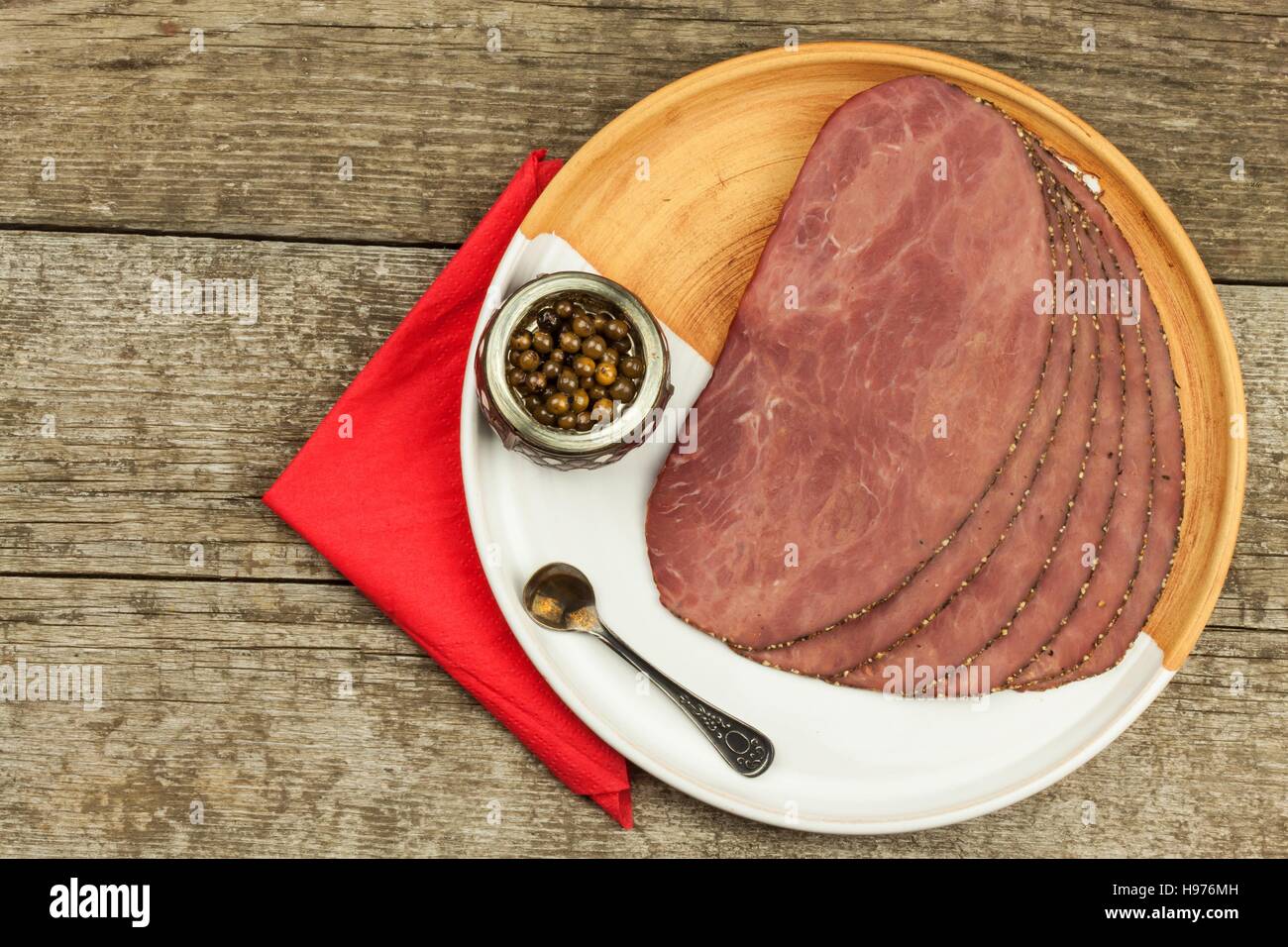 Cold roast beef on a wooden table. Delicacy of beef. Preparing cold ...