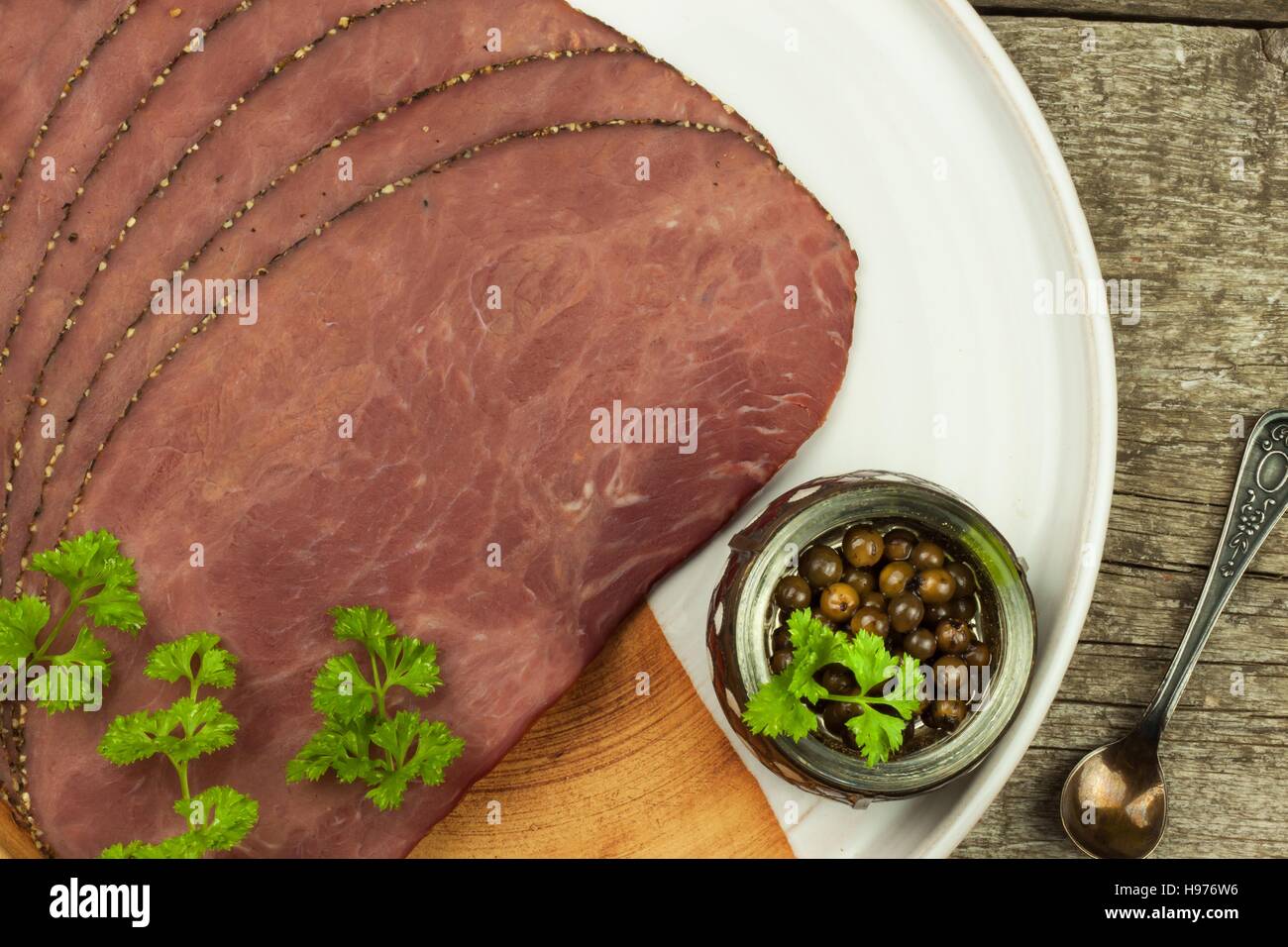 Cold roast beef on a wooden table. Delicacy of beef. Preparing cold ...