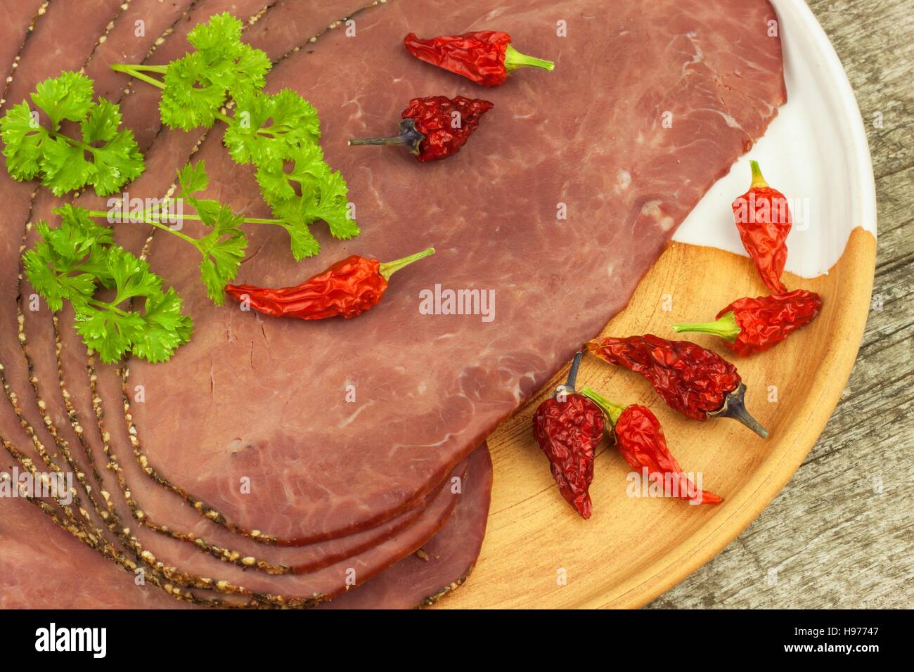 Cold roast beef on a wooden table. Delicacy of beef. Preparing cold ...