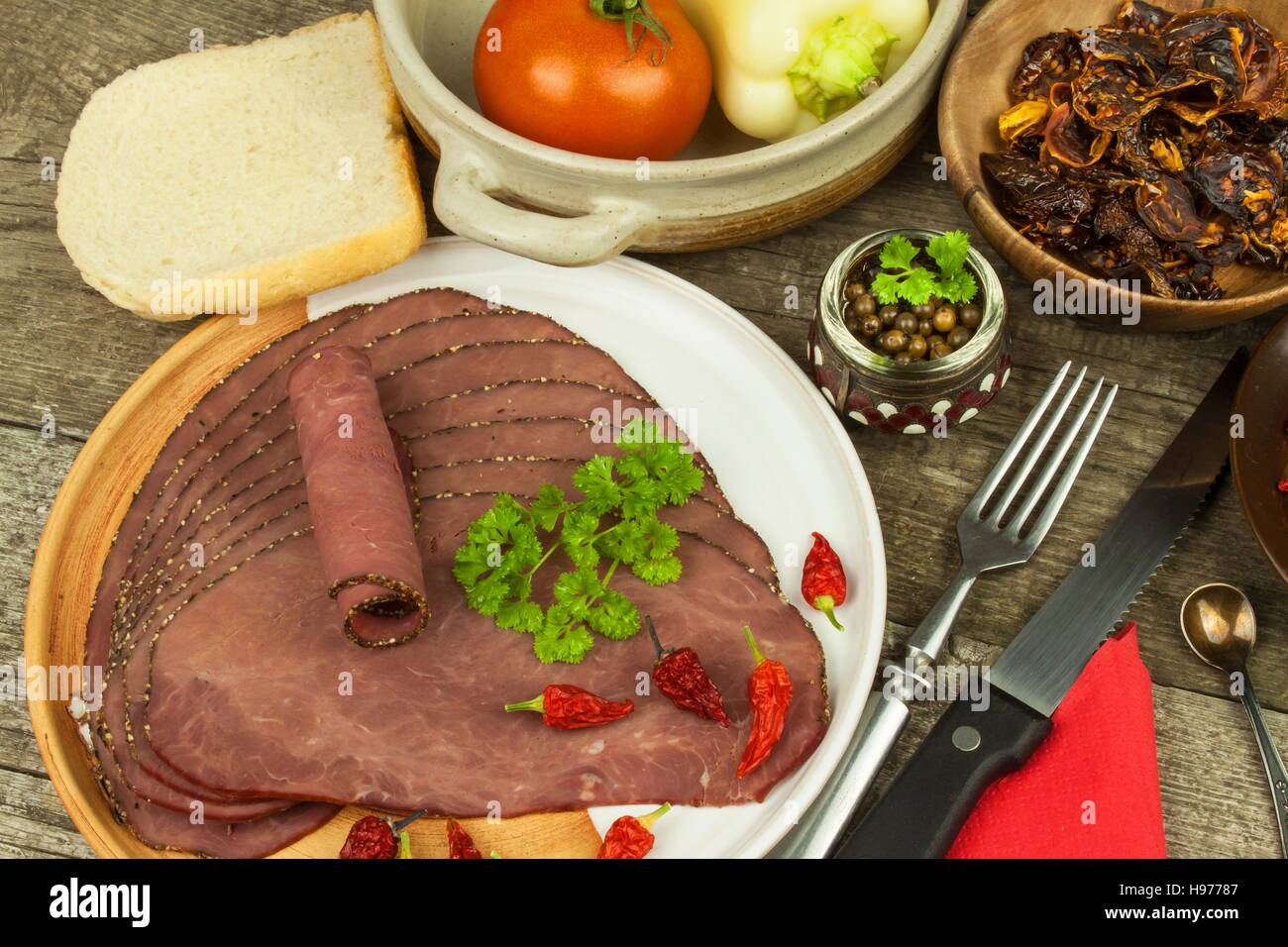 Cold roast beef on a wooden table. Delicacy of beef. Preparing cold ...