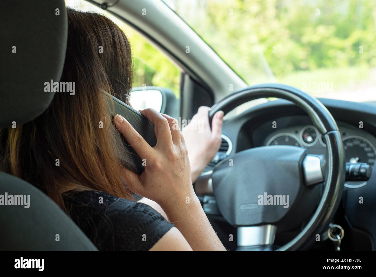 woman riding in a car and talking on the phone Stock Photo - Alamy