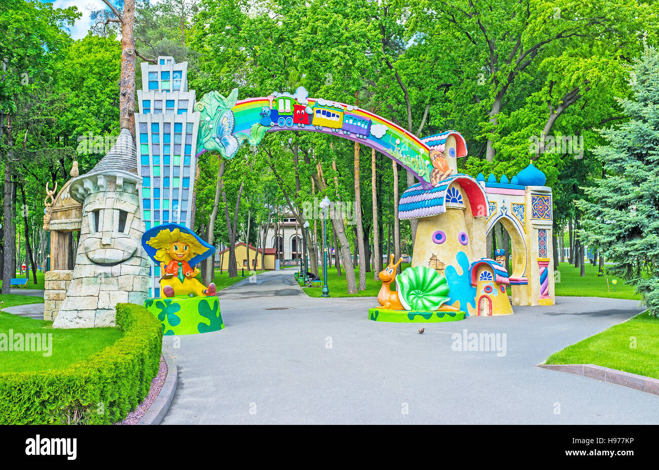 The gate to amusement park with the castles, towers, toy train on the ...