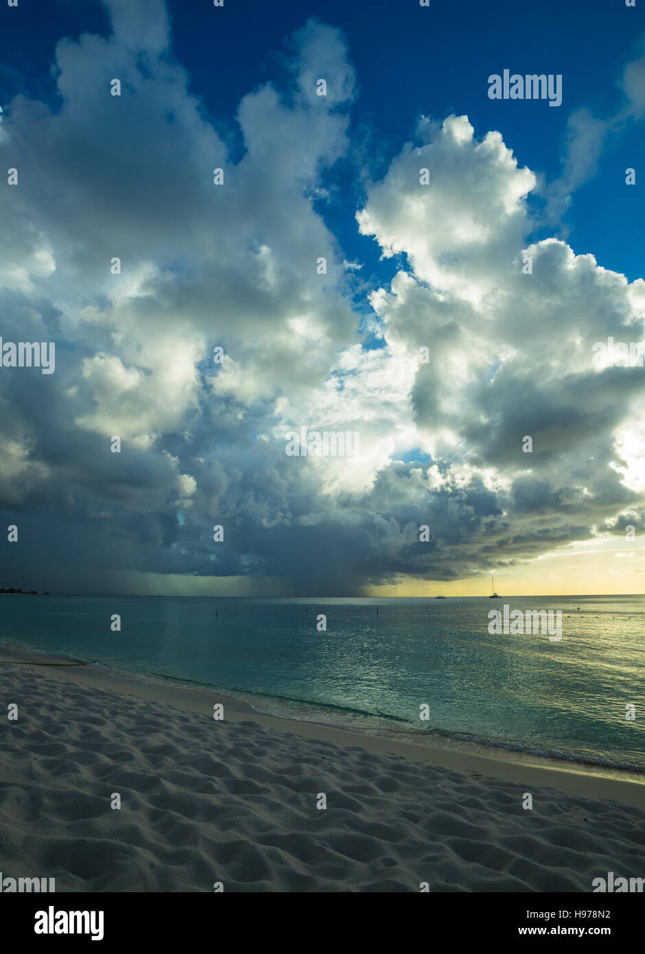 sunset over a tropical sea with golden sky and clouds Stock Photo - Alamy