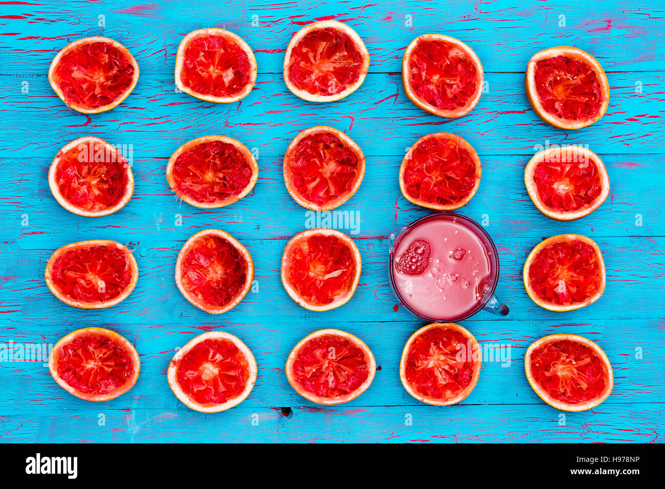 Colorful exotic still life of squeezed bright pink ruby grapefruit ...