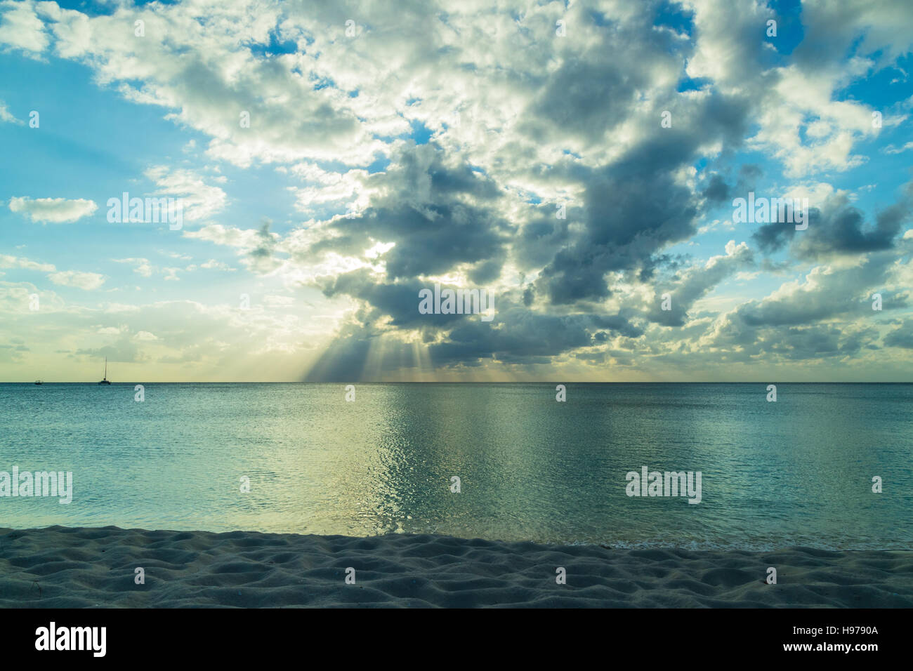 sunset over a tropical sea with golden sky and clouds Stock Photo - Alamy