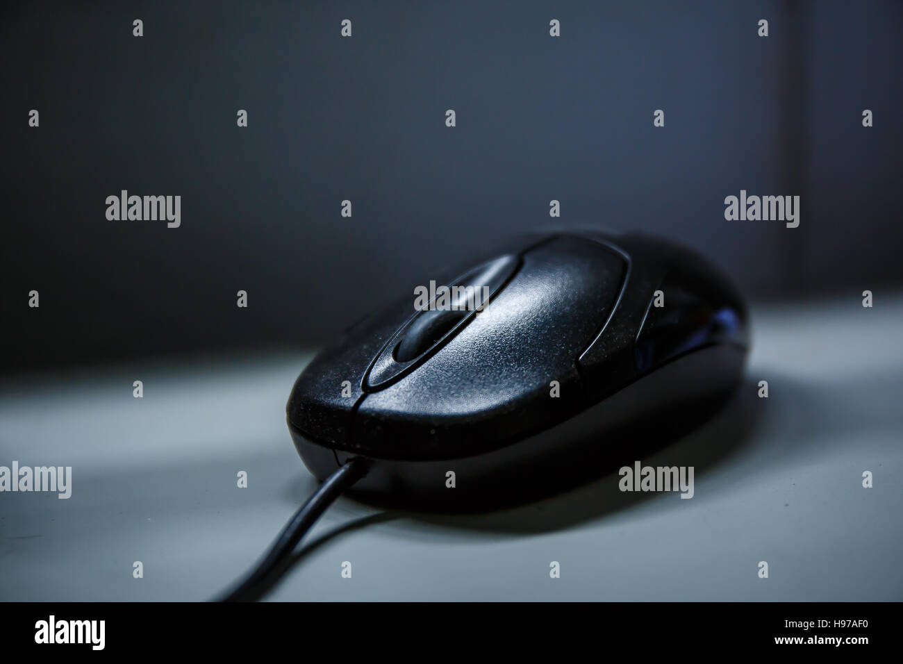 Black computer mouse on a black background Stock Photo - Alamy