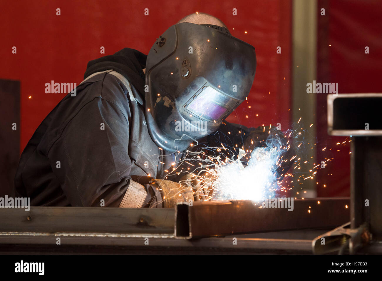 A male welder welding steel metal in a workshop Stock Photo - Alamy
