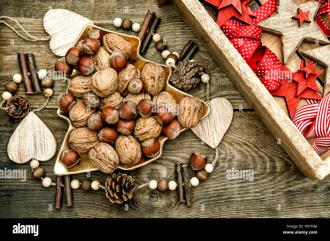 Walnuts with christmas decorations wooden stars and red ribbons ...