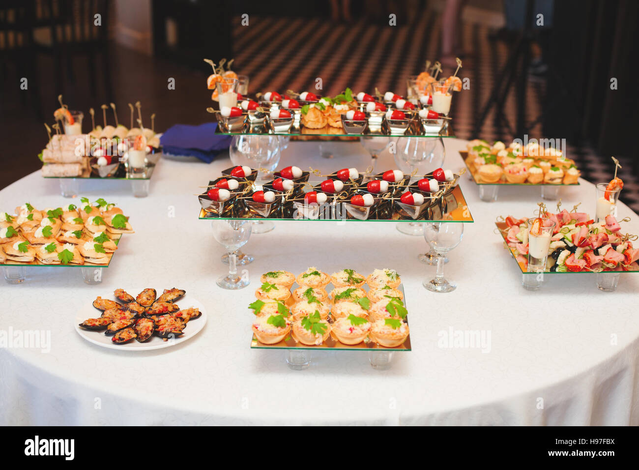 Table with assortment of canapes snacks. Banquet service Stock Photo ...