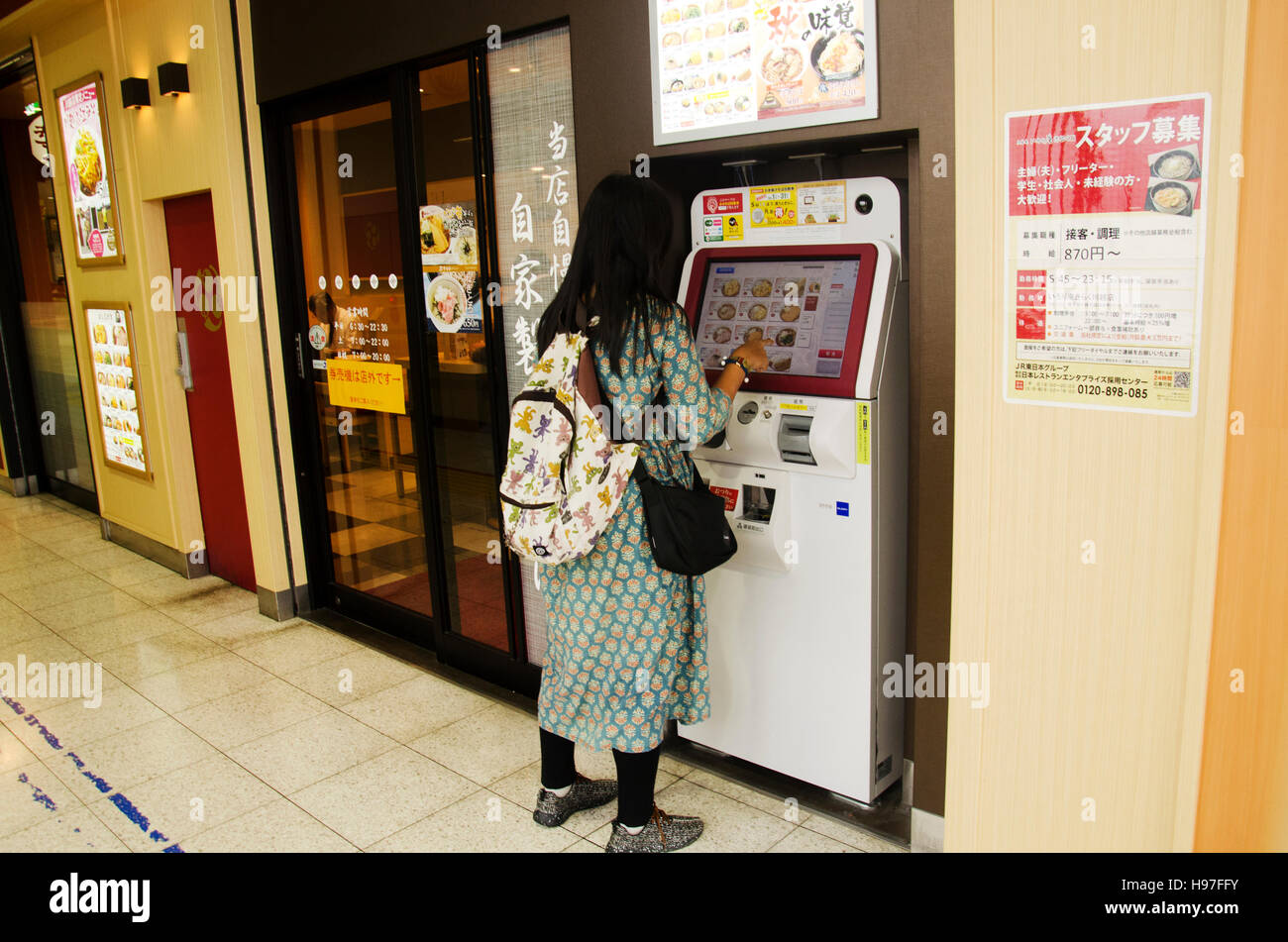 Traveller thai woman buying ramen from vending machine at Noodle ramen ...