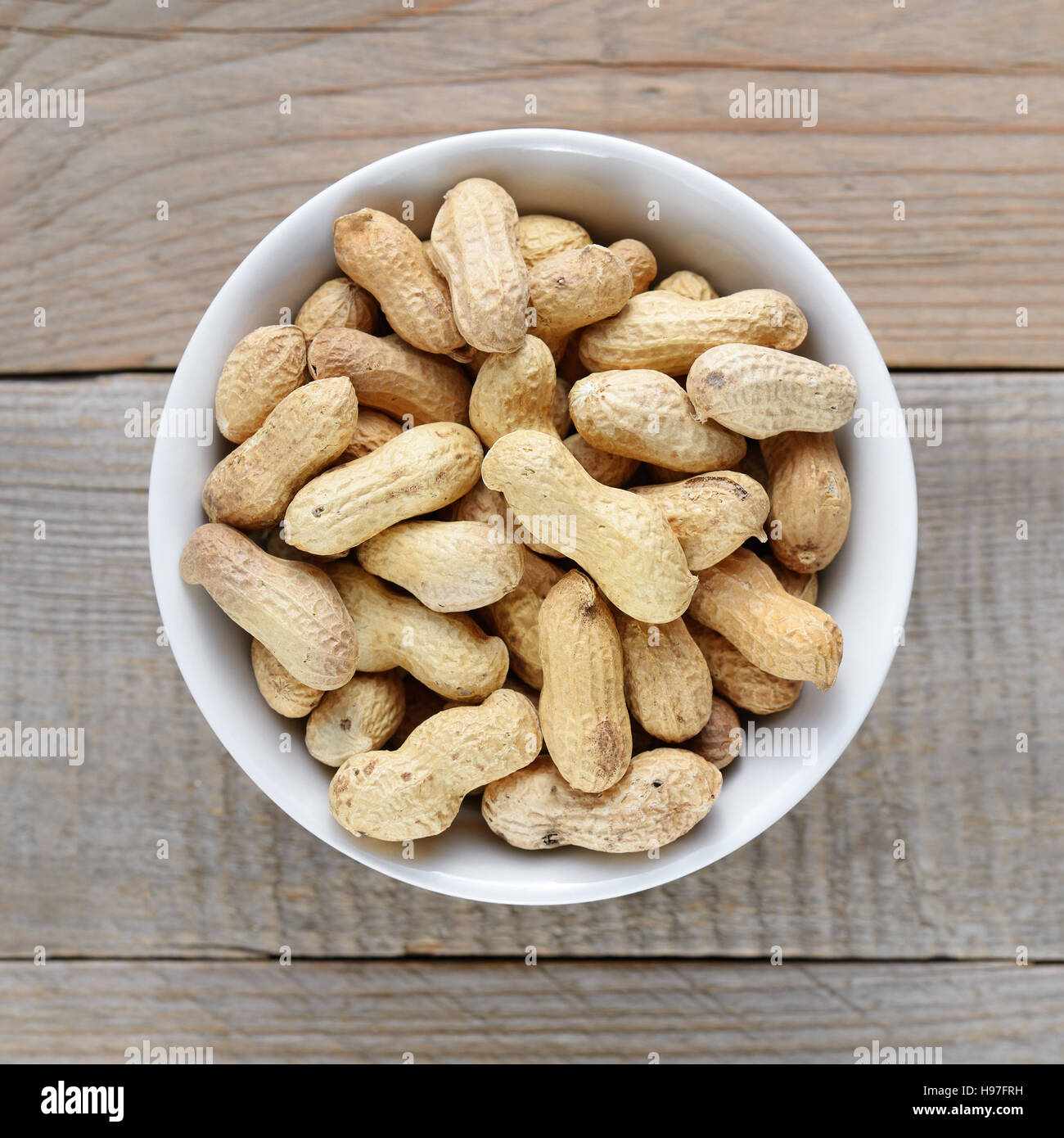Roasted peanuts closeup in bowl top view Stock Photo - Alamy