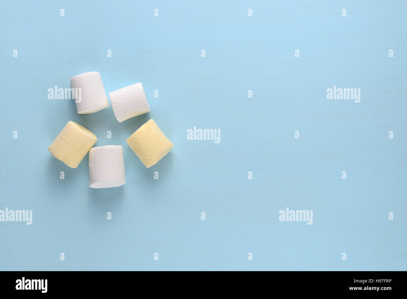 Marshmallow on blue table top view Stock Photo - Alamy