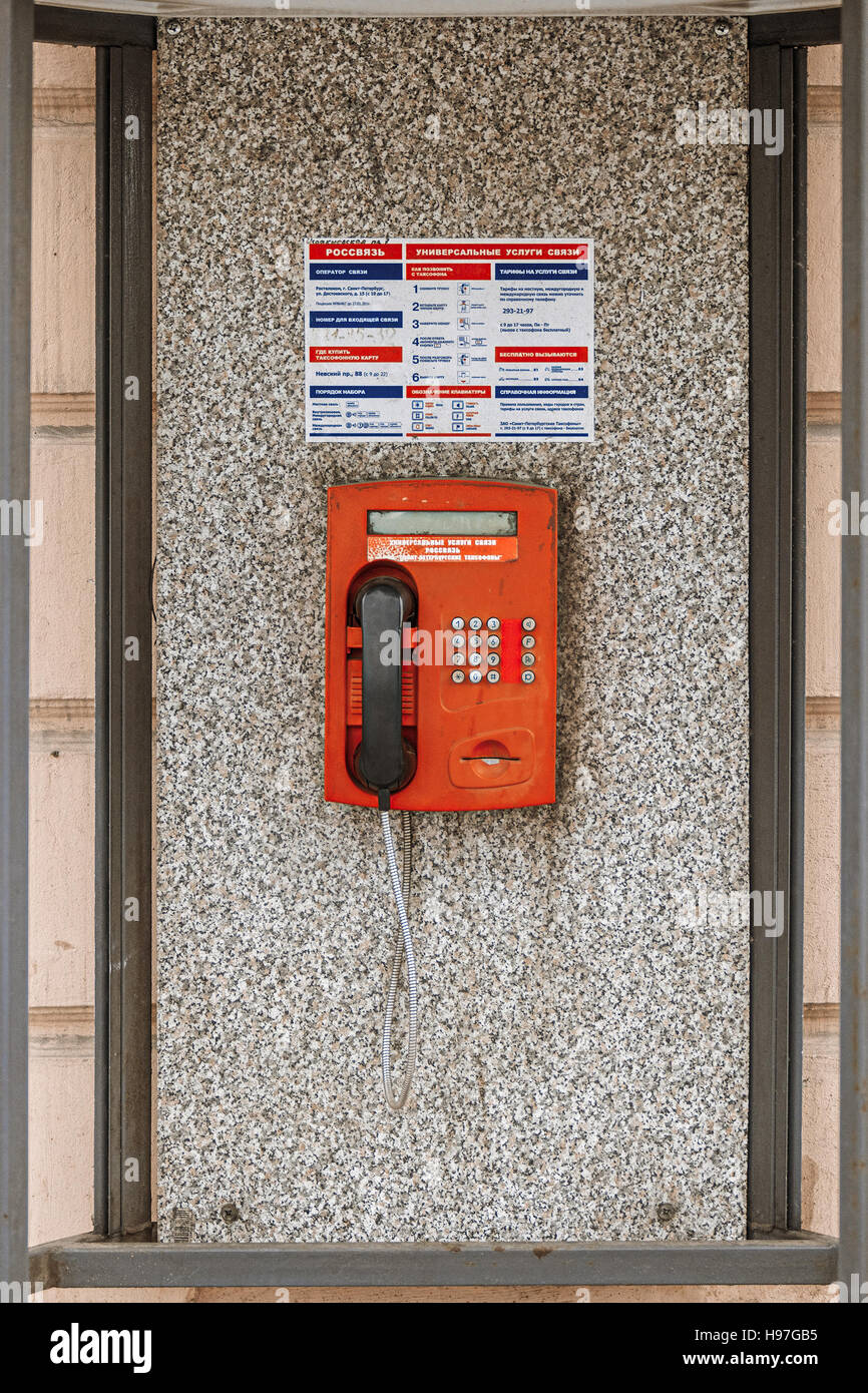 Public pay phone of red color in phone booth in St Petersburg Russia ...