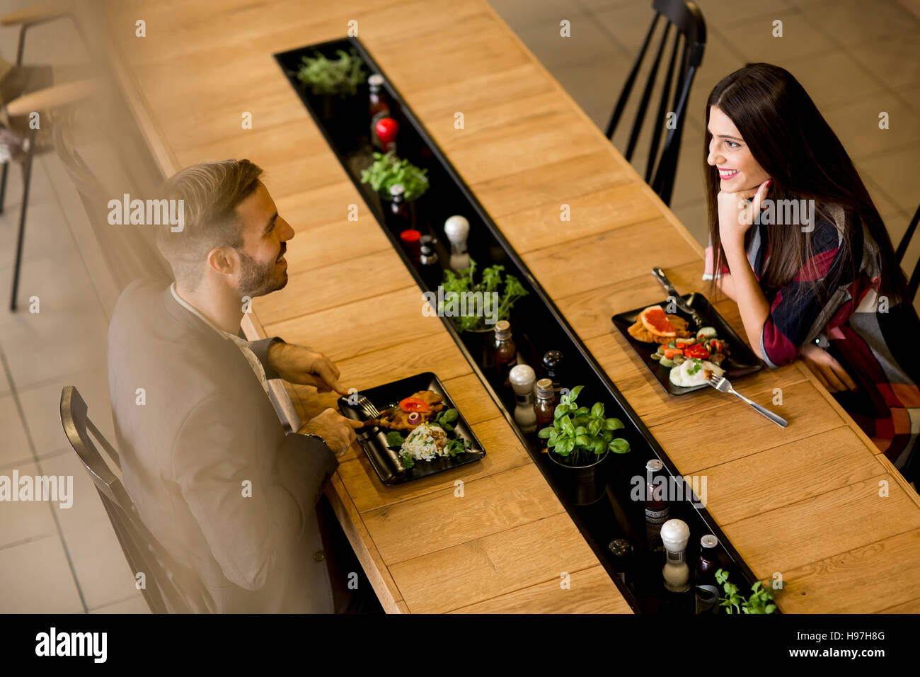 Young loving couple having lunch in the modern restaurant Stock Photo ...