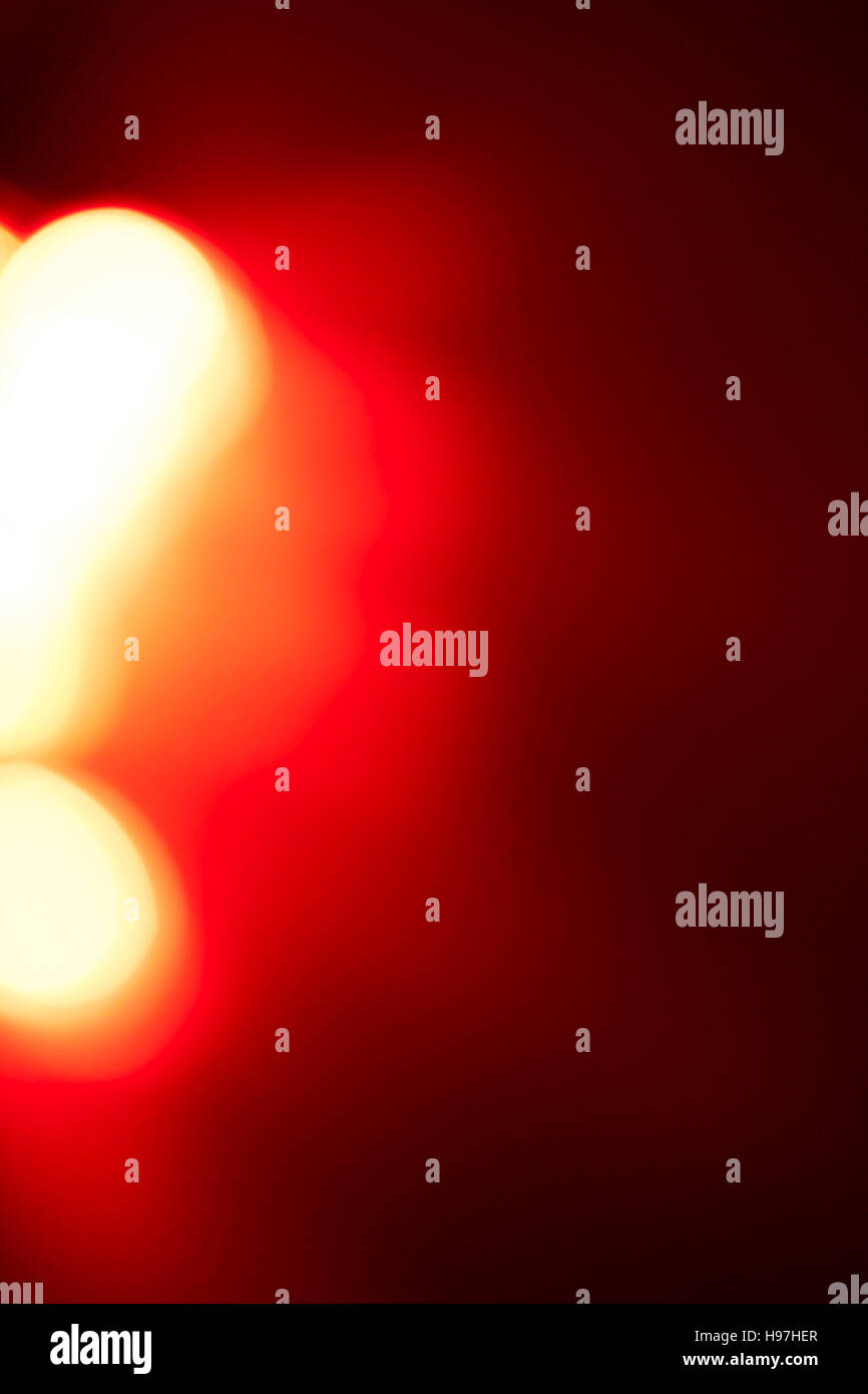 Polygonal red colored light beams in center of solid black background ...