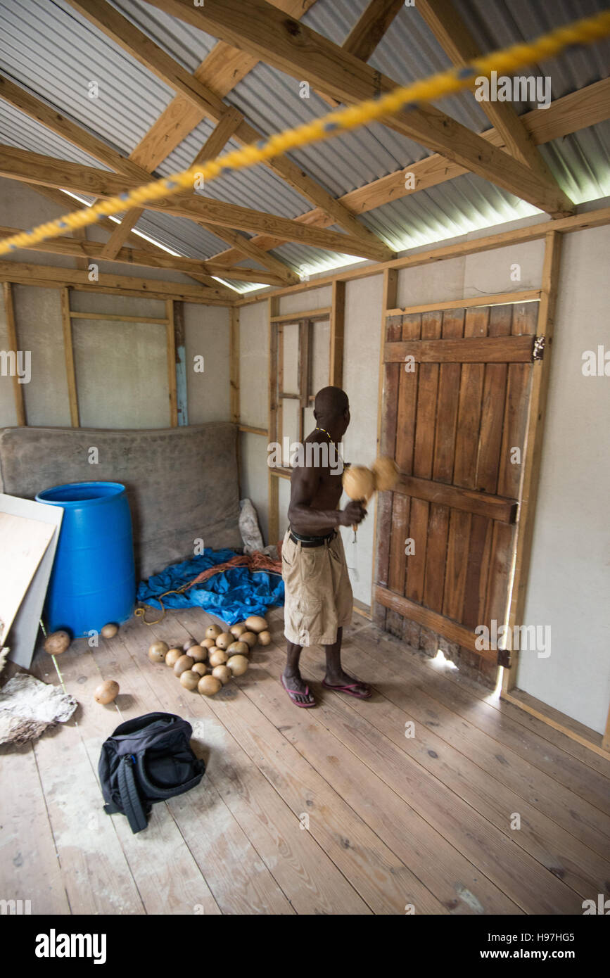 Belize Man in a hut showing shakers in small Village warm sunny day ...