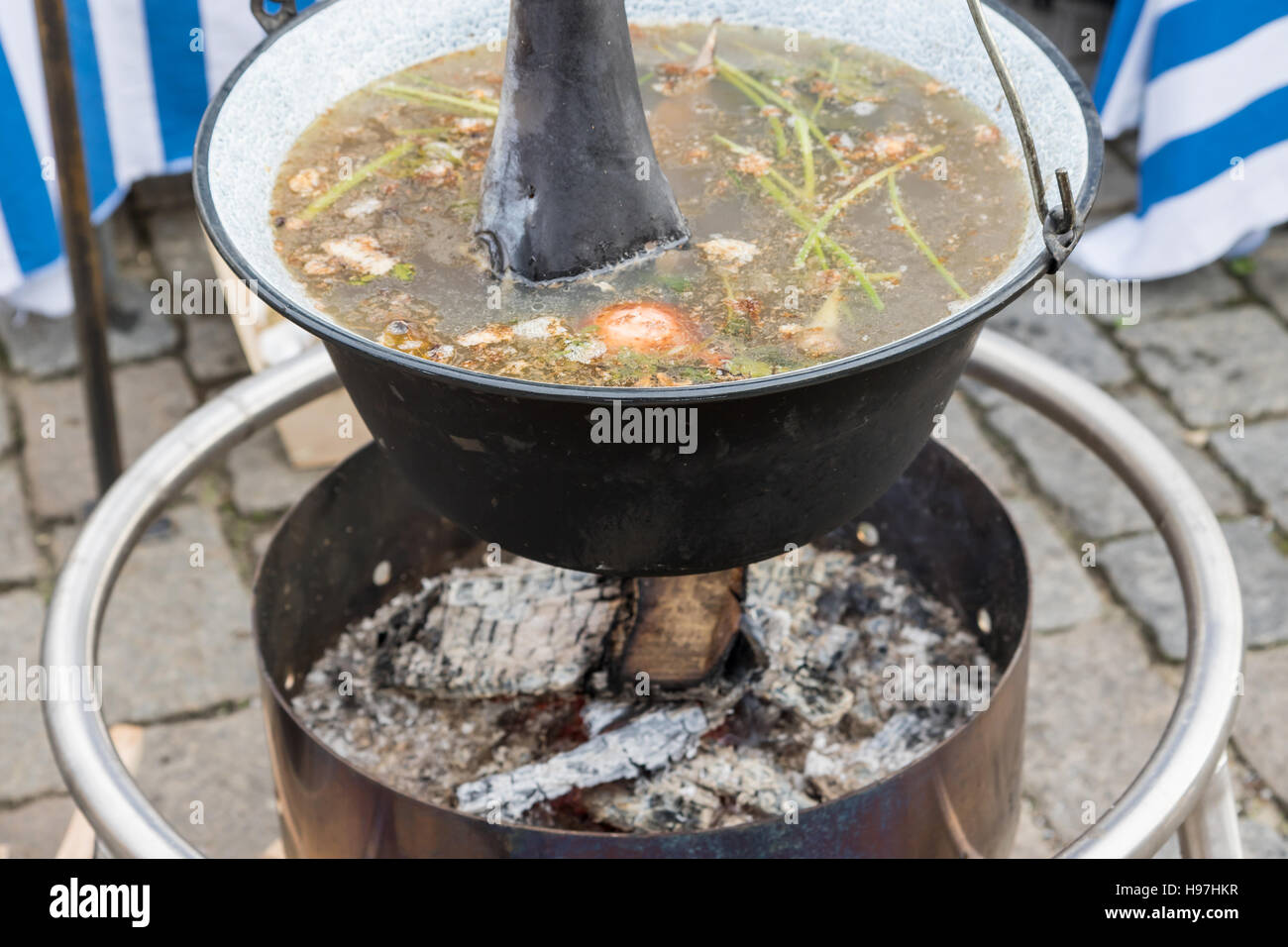 Street food - Cooking fish soup in the kettle over an open fire. All ...