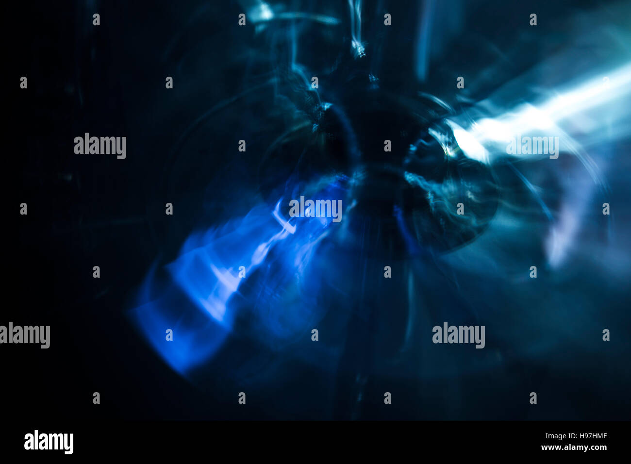 Chaotic background with radial directions of light streaks in blue and ...