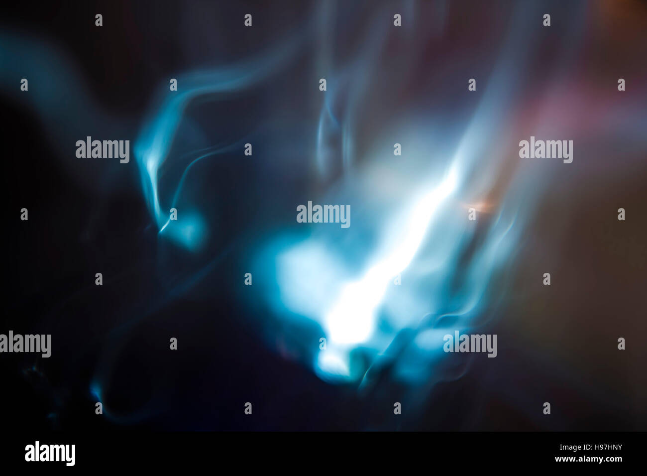 Glowing hazy light in blue and violet colored cloudy background with ...