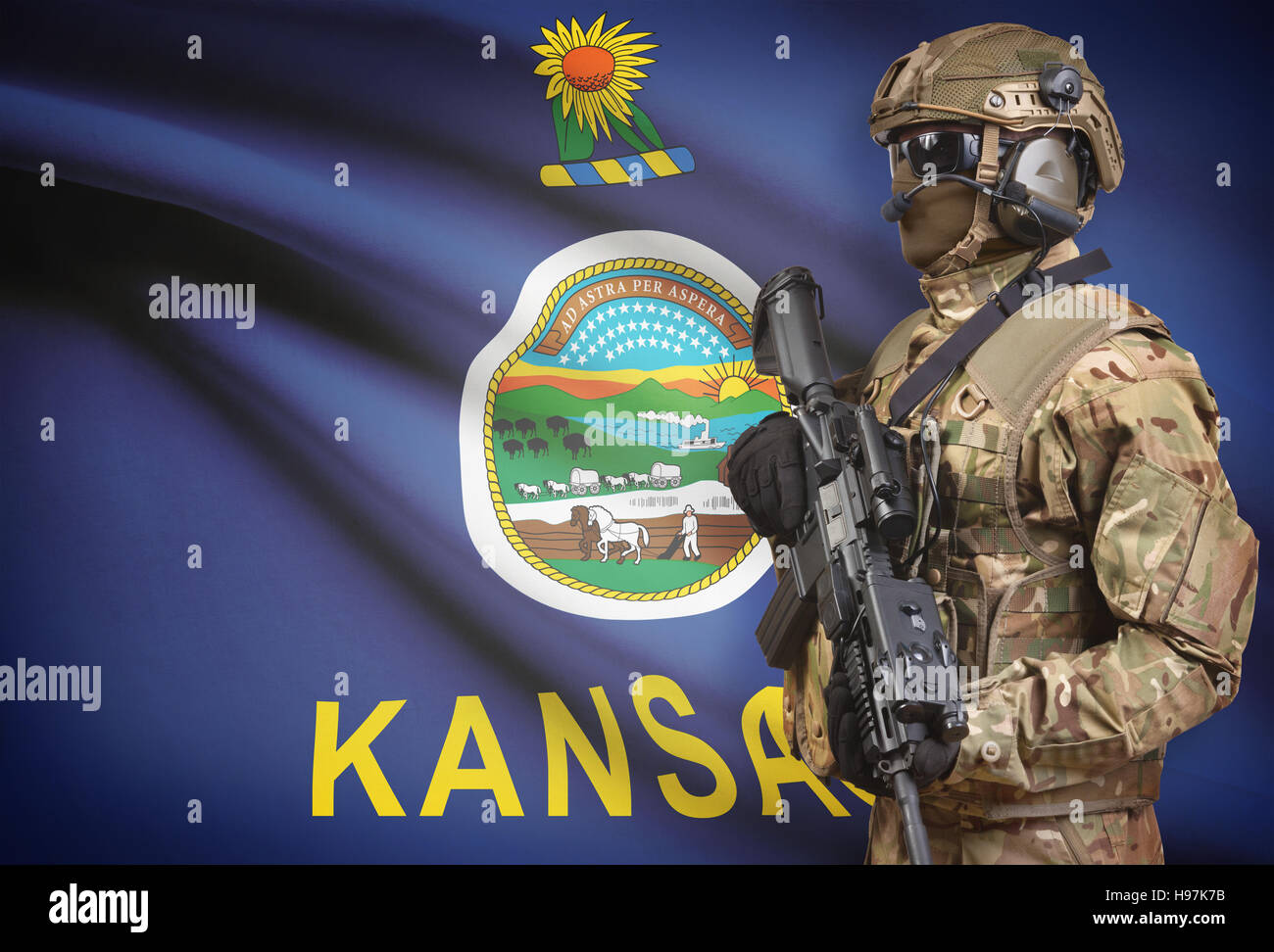 Soldier in helmet holding machine gun with USA state flag on background ...